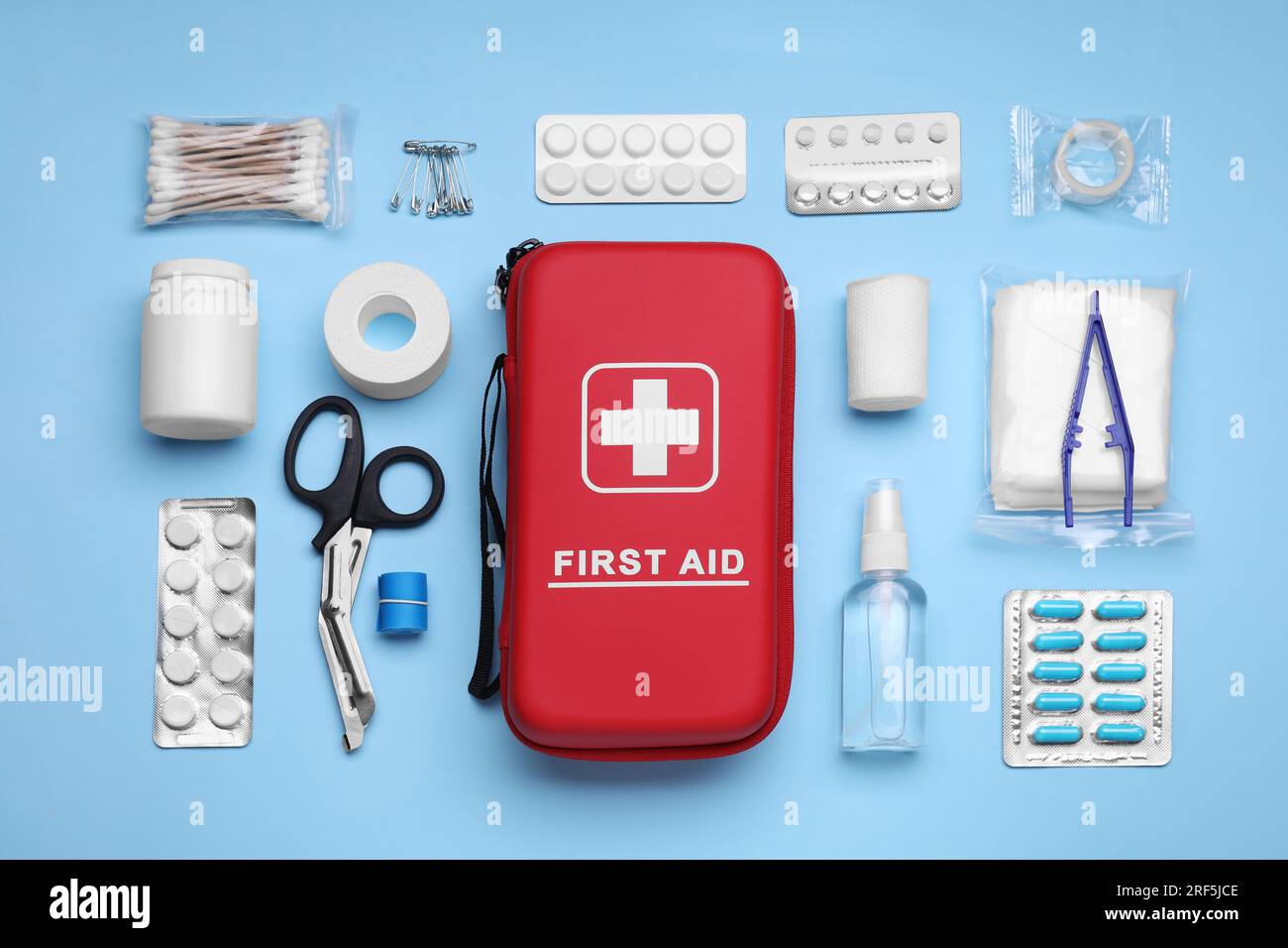 Flat lay composition with first aid kit on light blue background Stock ...