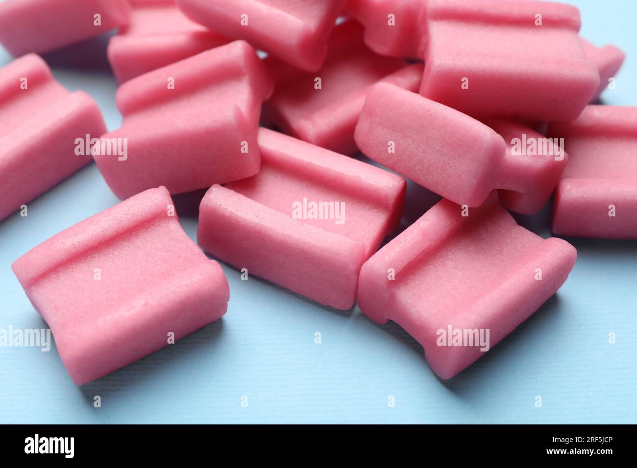 Tasty pink chewing gums on light blue background, closeup Stock Photo ...