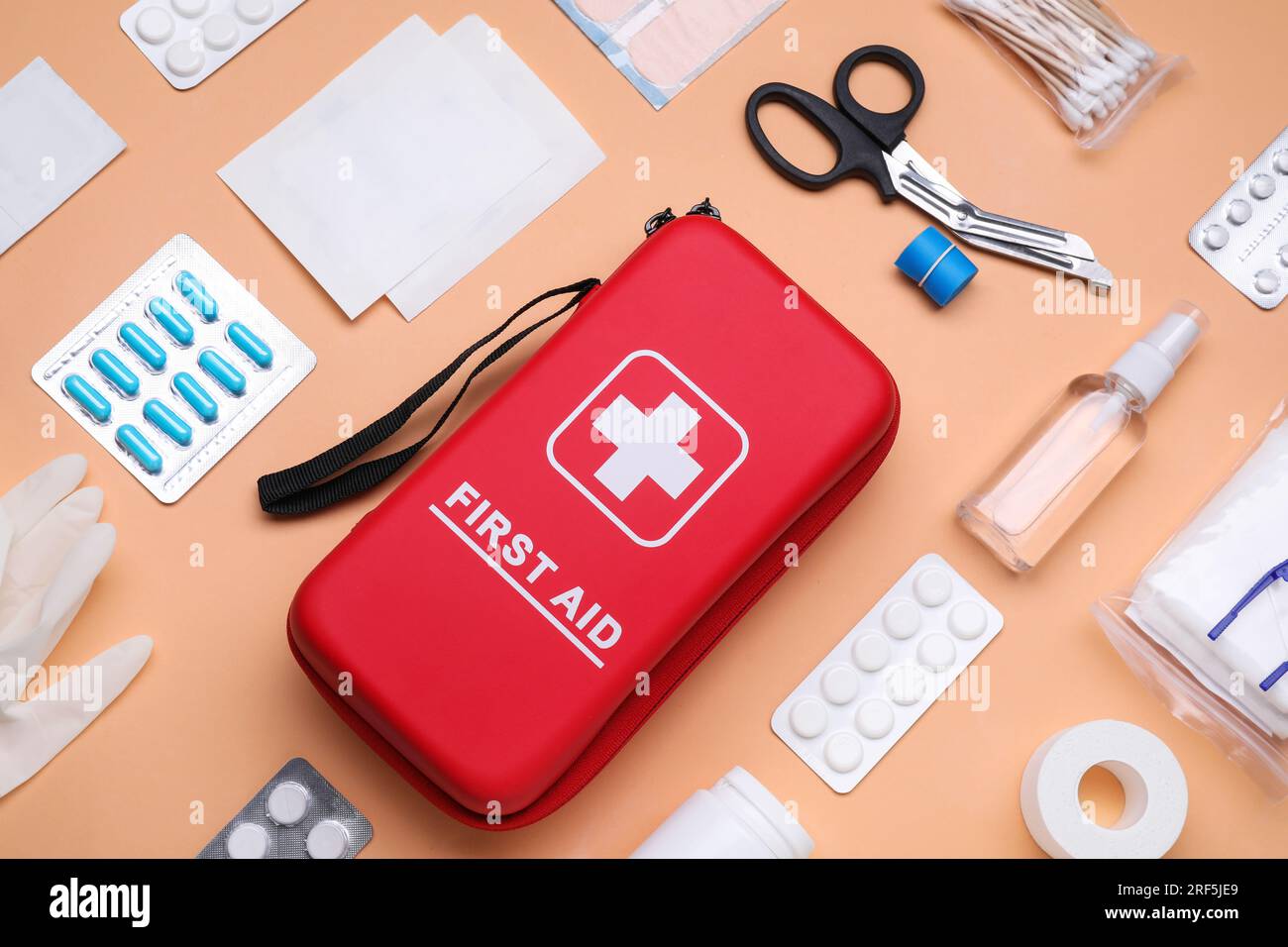 Flat lay composition with first aid kit on pale coral background Stock ...