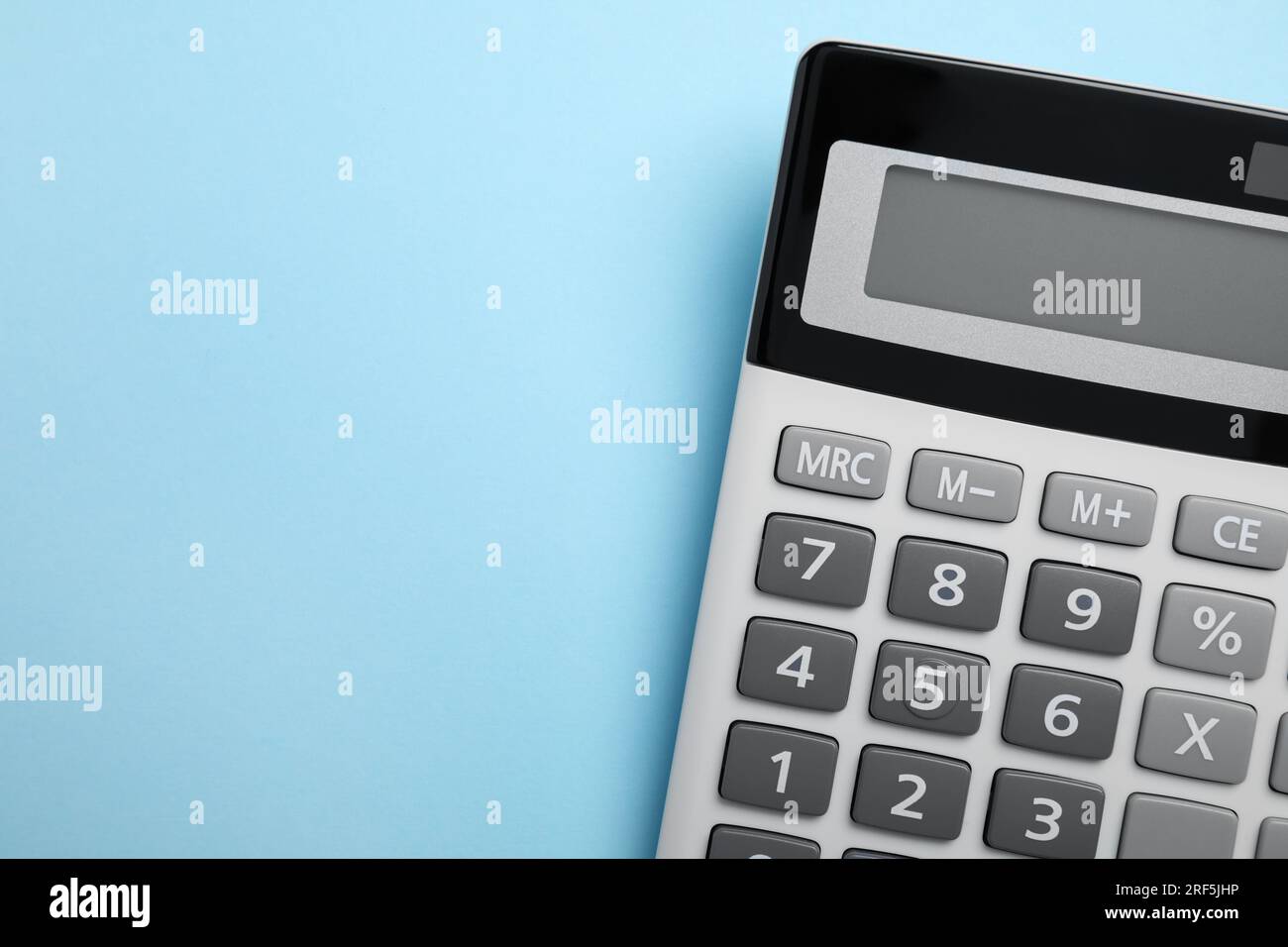 Calculator on light blue background, top view. Space for text Stock ...