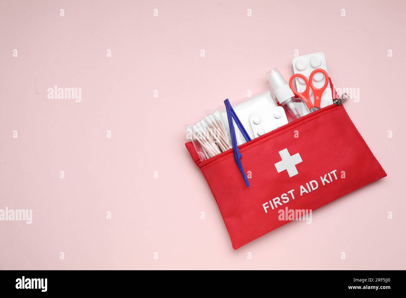 First aid kit on pink background, top view. Space for text Stock Photo ...