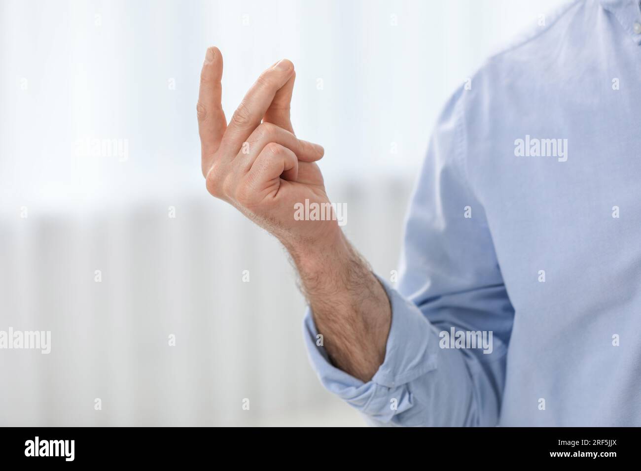Man snapping his fingers indoors, closeup. Bad habit Stock Photo - Alamy