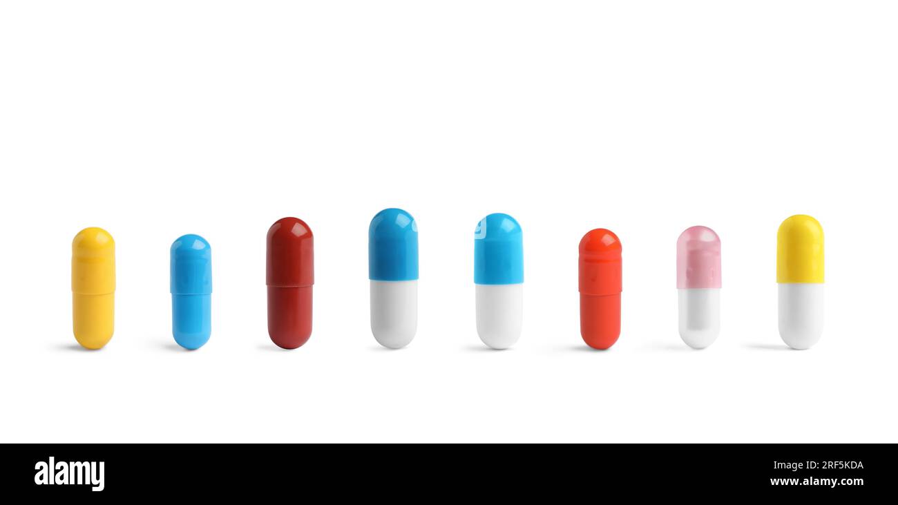 Set of different color pills in row isolated on white Stock Photo - Alamy
