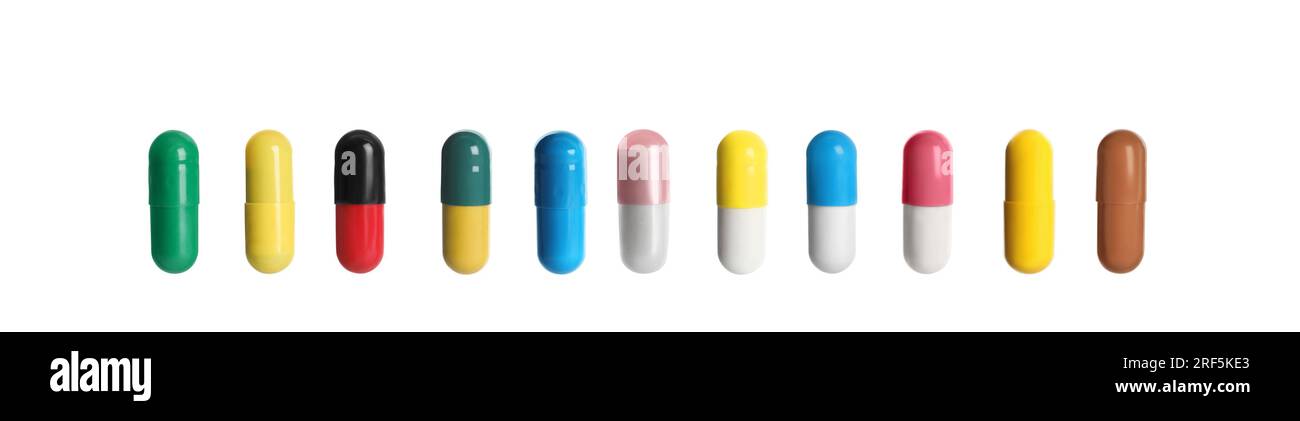 Set of different color pills in row isolated on white Stock Photo - Alamy
