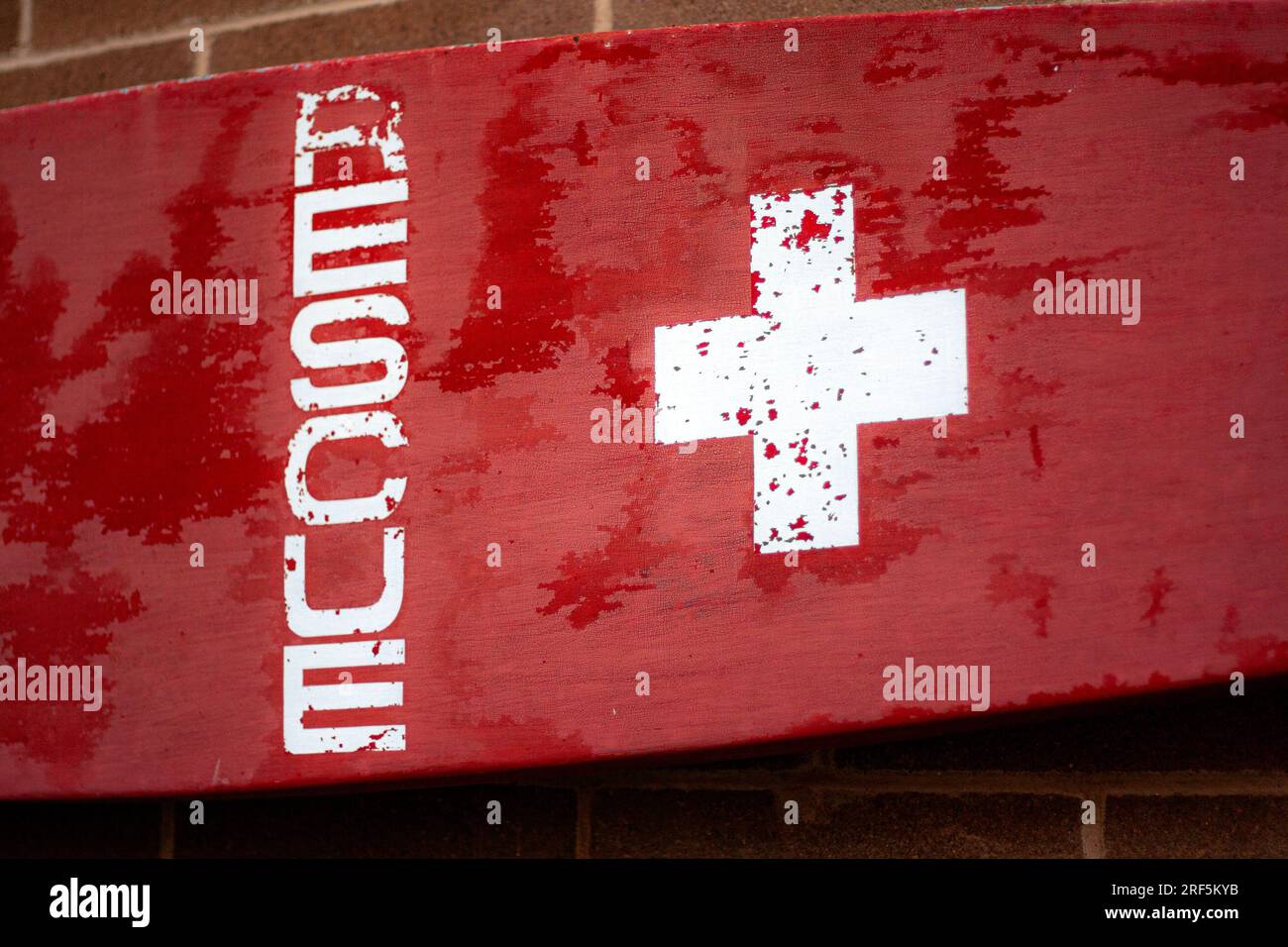 A red lifeguard surfboard with Rescue and a white cross Stock Photo - Alamy