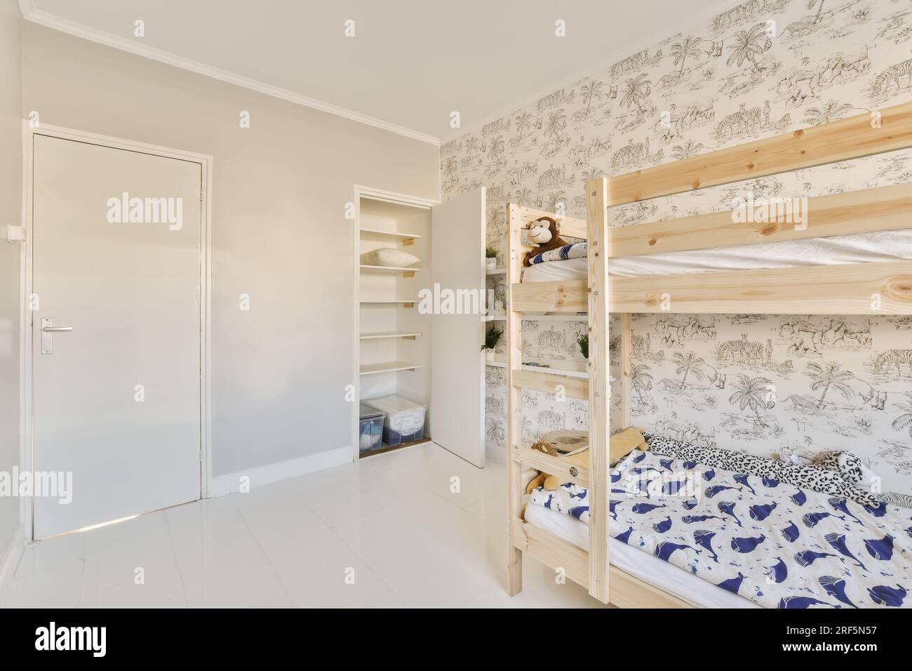 a kid's room with two bunk beds and a wallpapered closet behind the bed ...