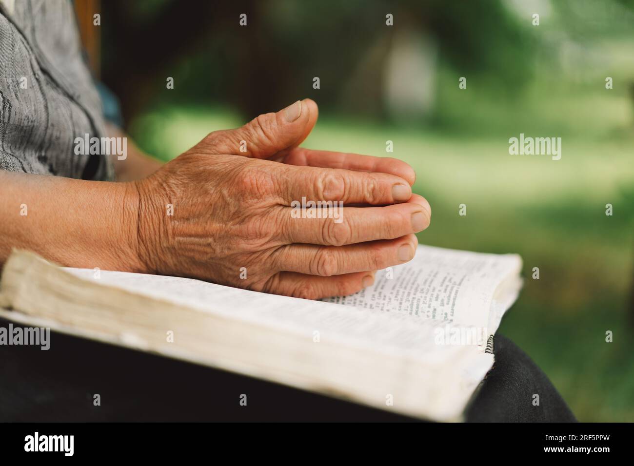 Old woman praying for hope or reading holy bible Stock Photo - Alamy