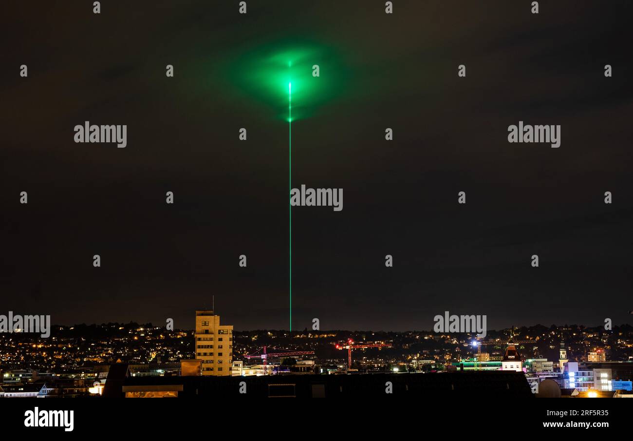 Stuttgart, Germany. 31st July, 2023. A green laser shines in the night ...