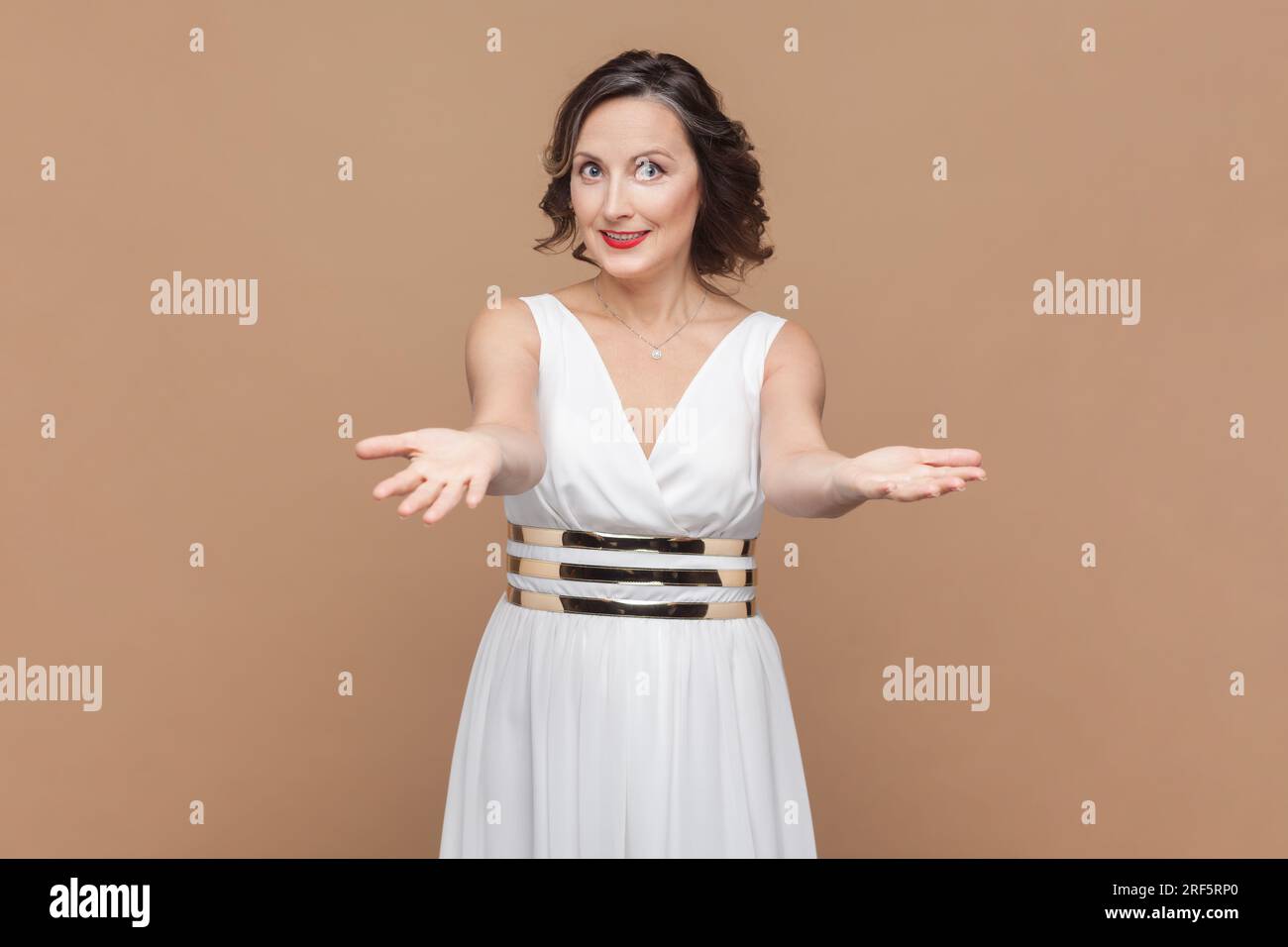 Please, take for free. Kind generous woman outstretching hands as if ...