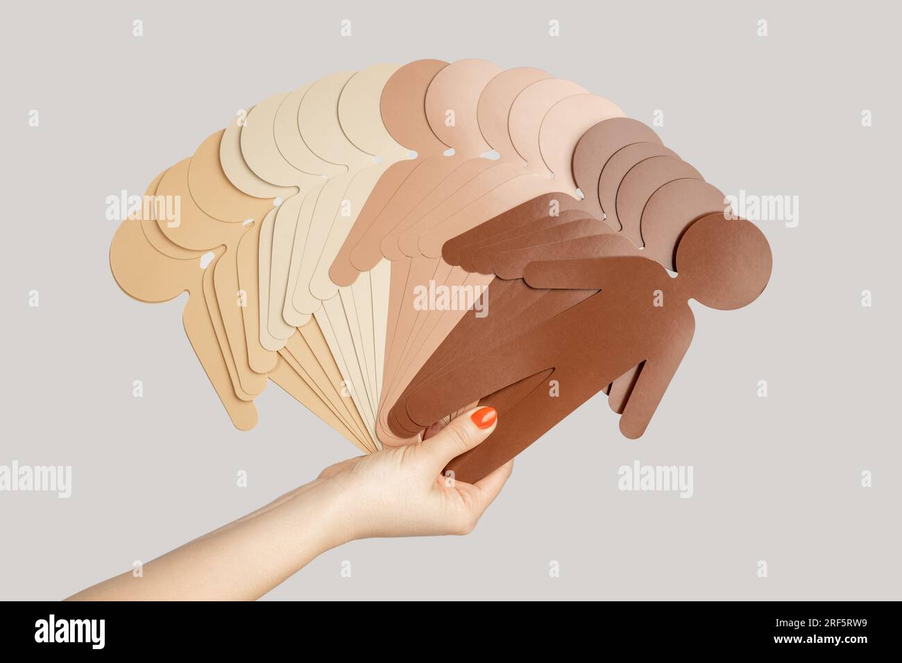 Closeup of woman hand showing paper symbols of multicultural people ...