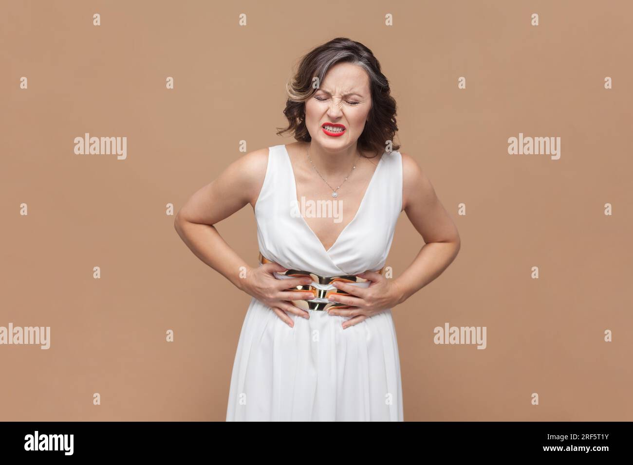 Portrait of unhealthy sick middle aged woman with wavy hair standing ...