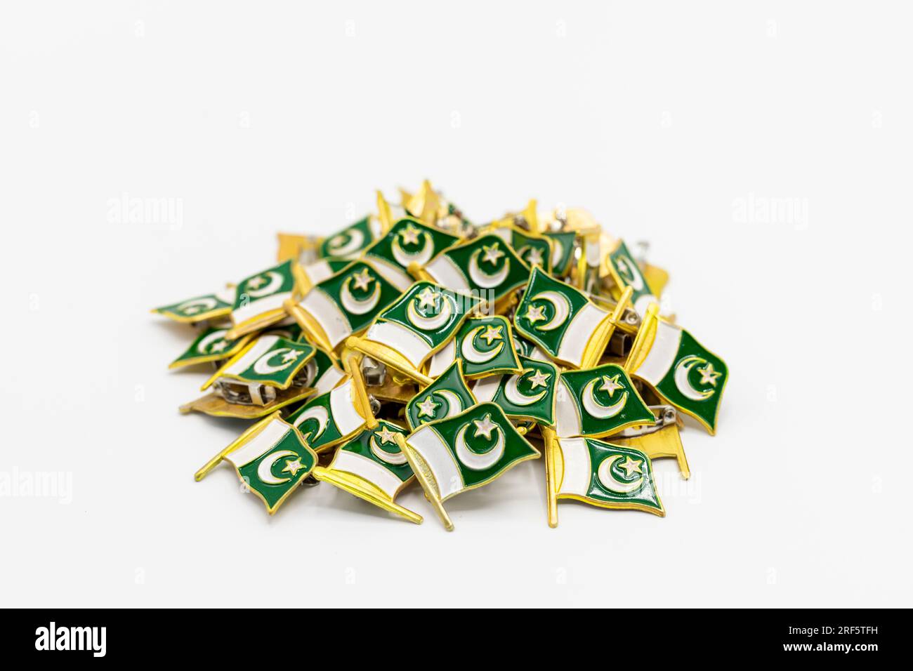 Pakistan flag badges pile closeup with selective focus on white ...