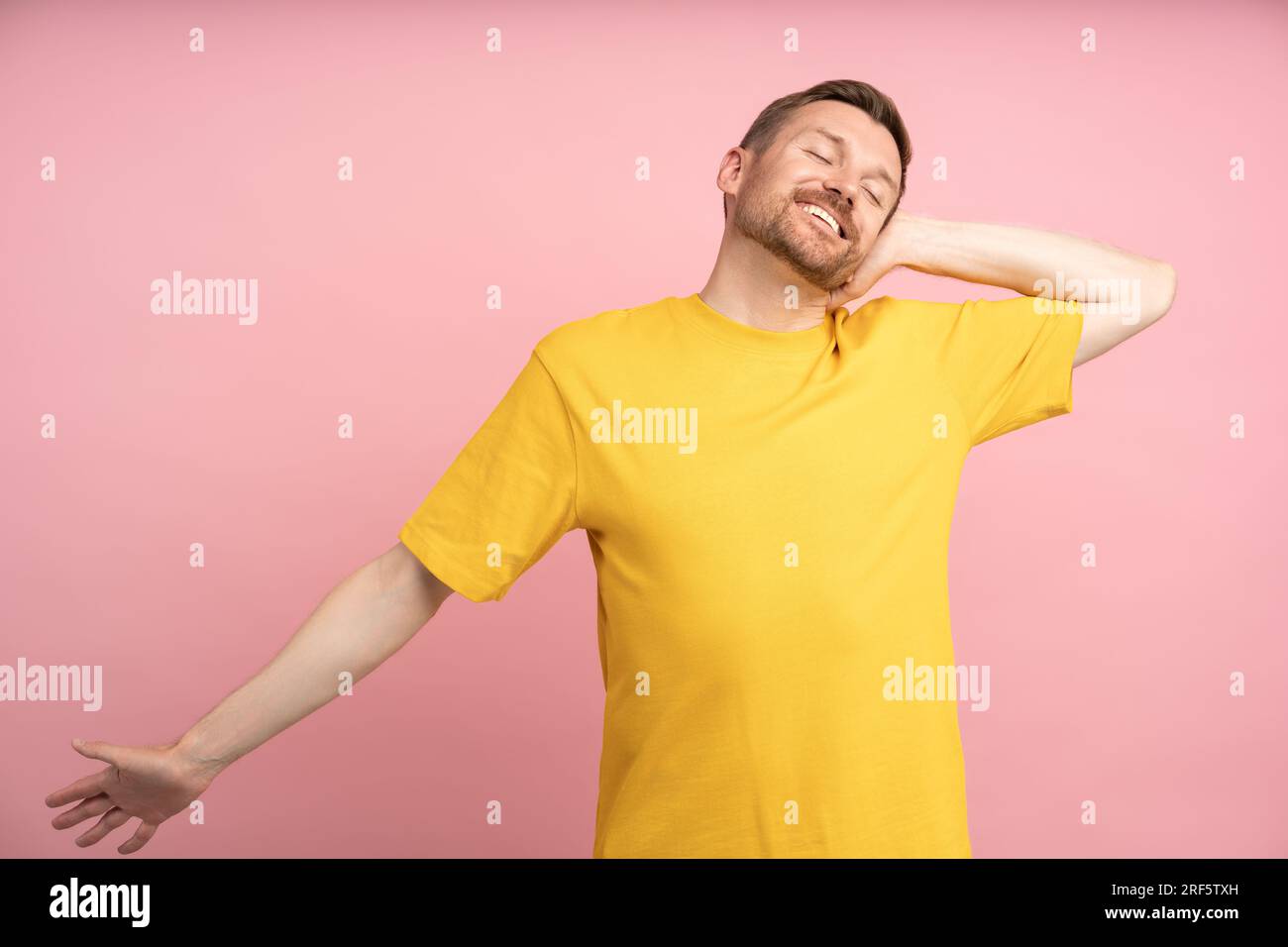 Happy well-rested man stretching smiling after good resting standing ...