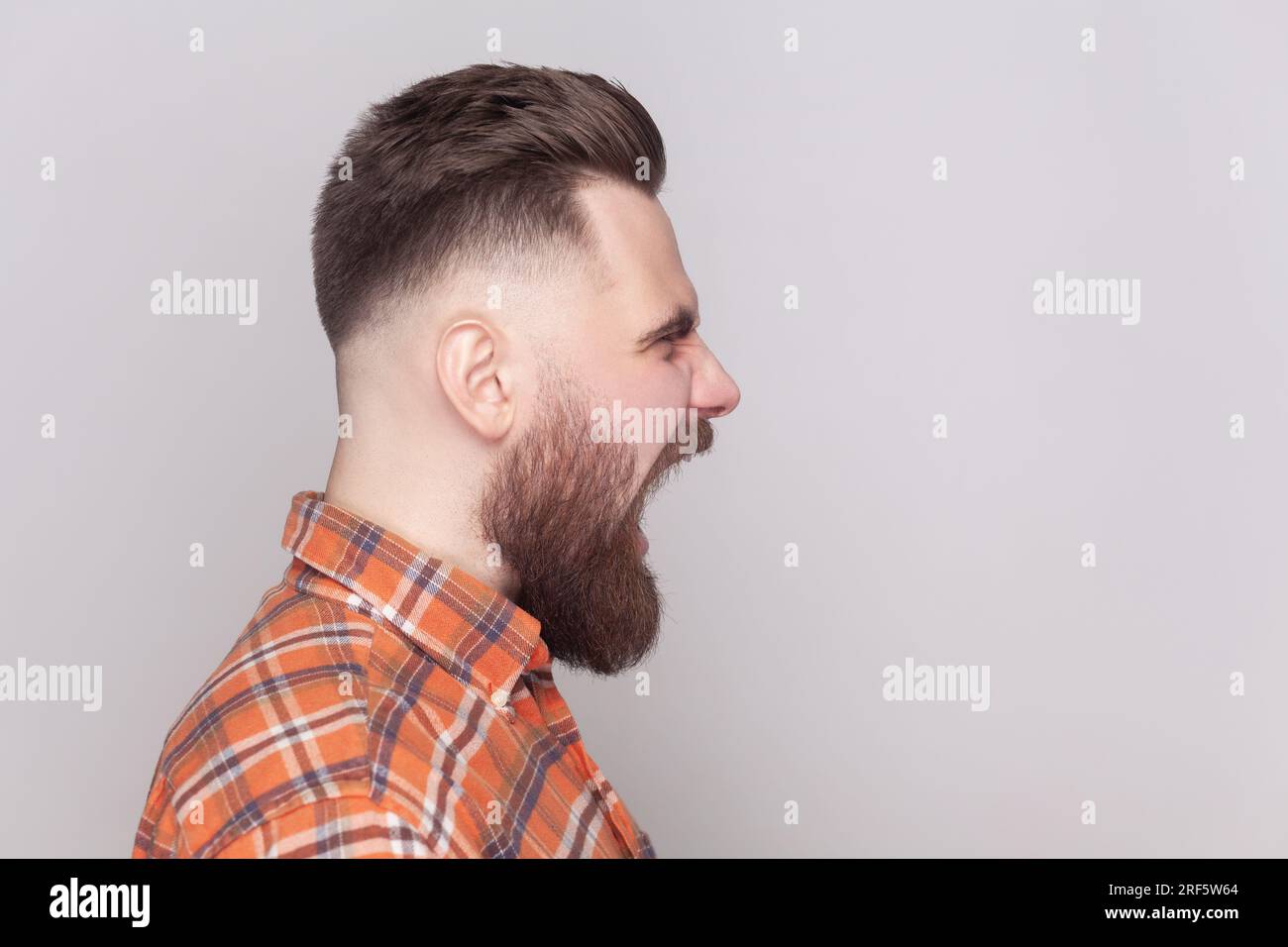 Side view portrait of serious strict angry bearded man standing looking ...