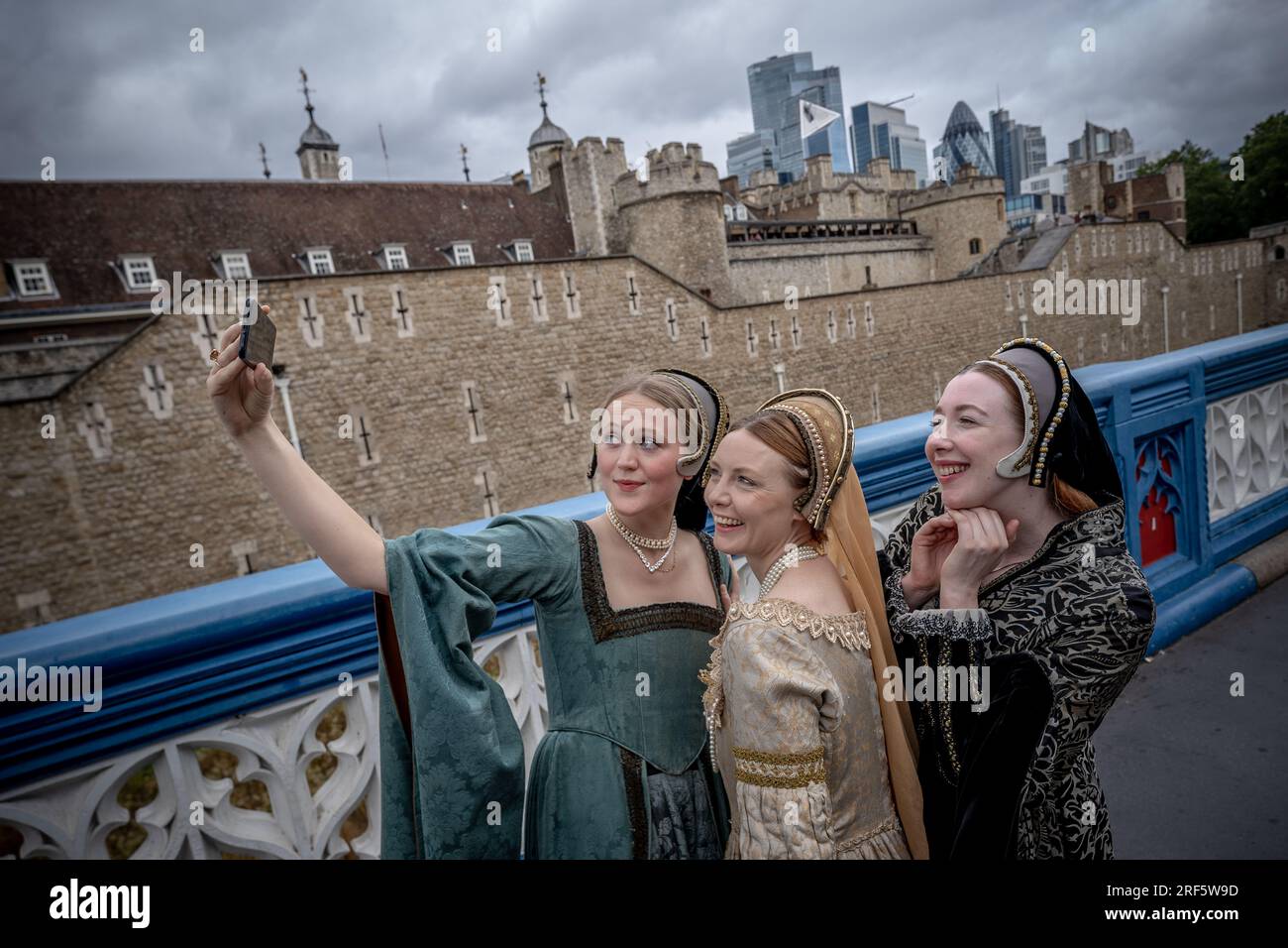Actors portraying three of the Boleyn sisters pose near the Tower of ...