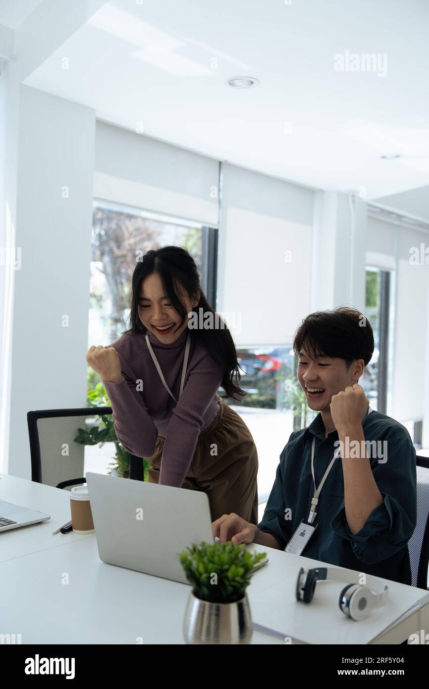 Success of happy employees smiling and laughing to celebrate project ...