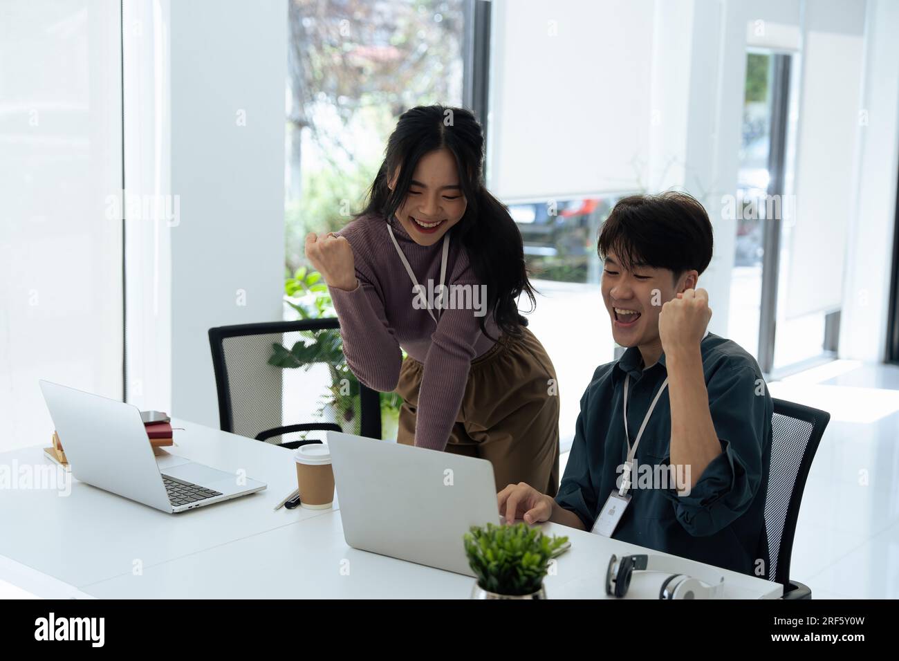 Success of happy employees smiling and laughing to celebrate project ...