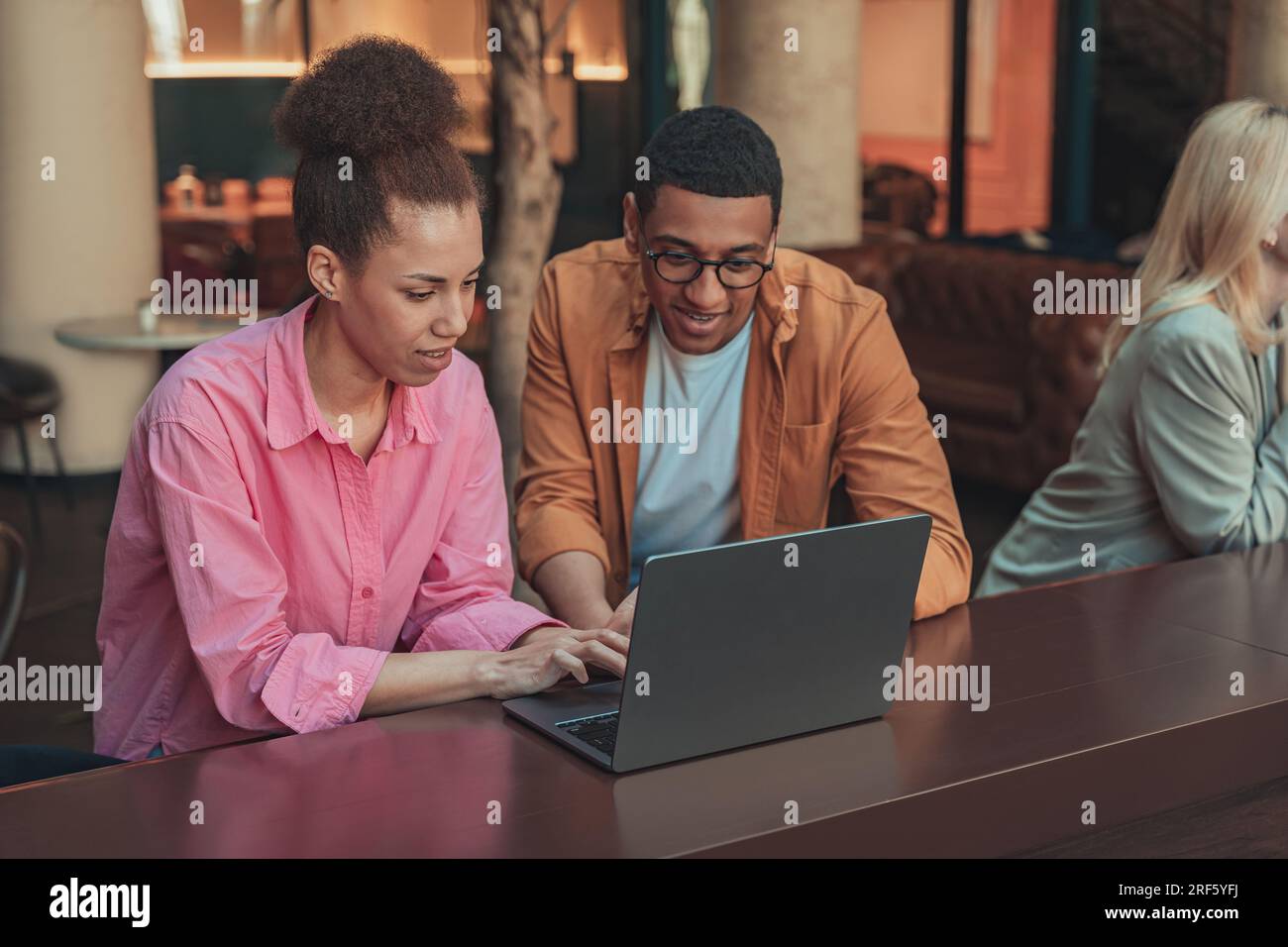 Friendly diverse business people laughing working on project together ...
