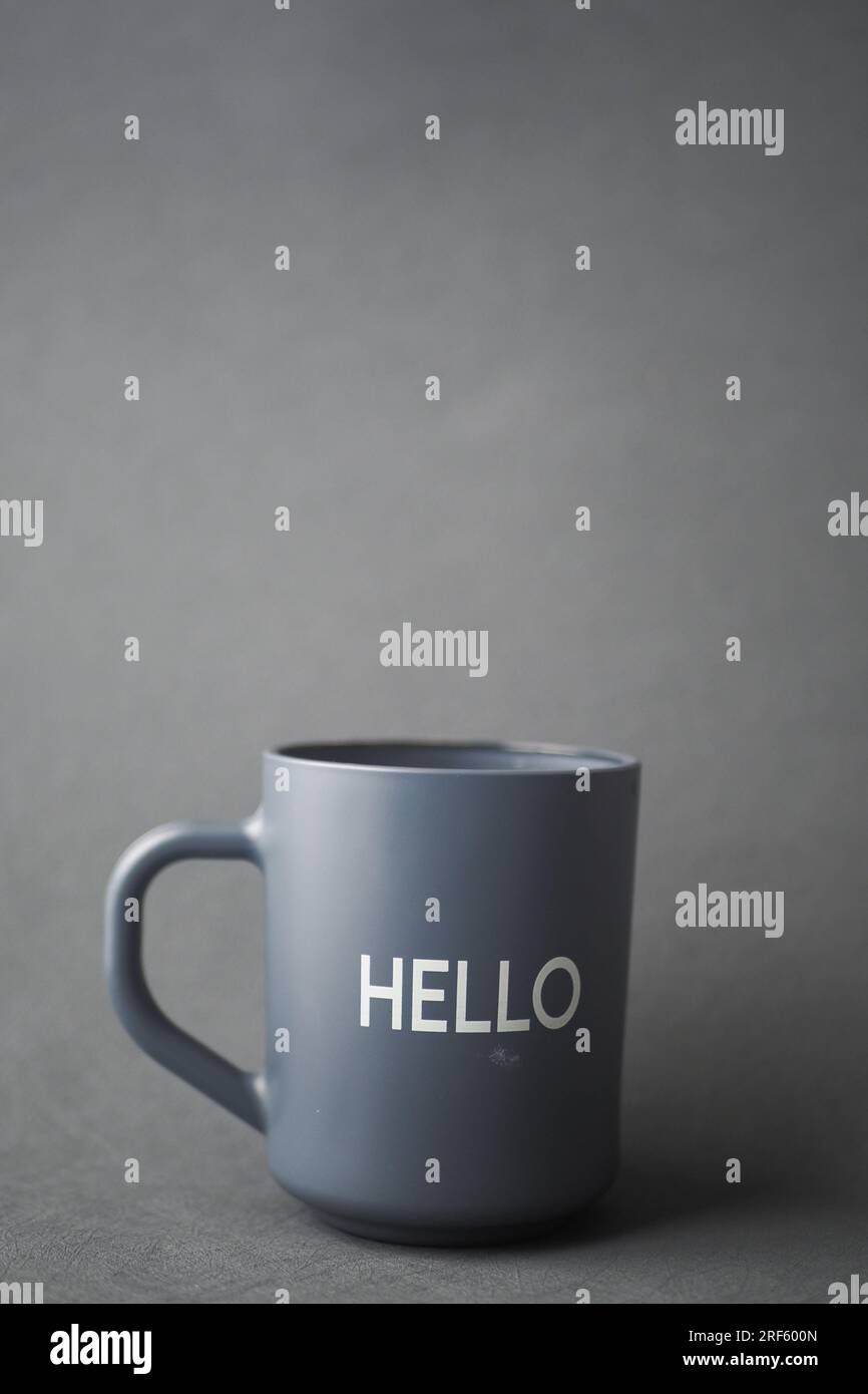 blue coffee cup with hello word on black background Stock Photo - Alamy