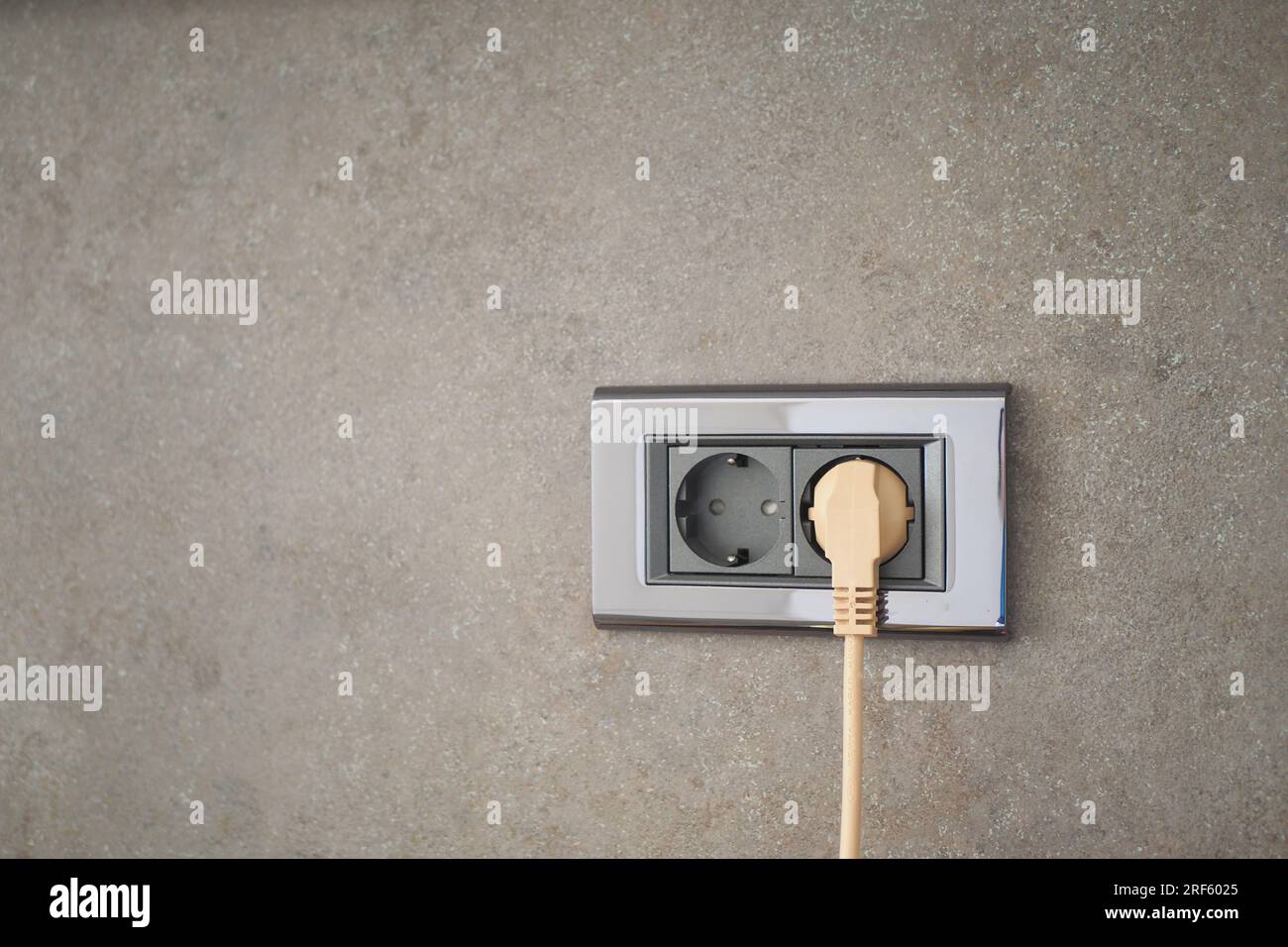 white color power cord cable plugged into wall Stock Photo - Alamy