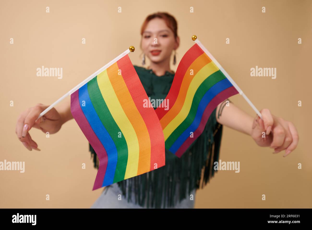 Excited transgender woman holding two rainbow flags Stock Photo - Alamy