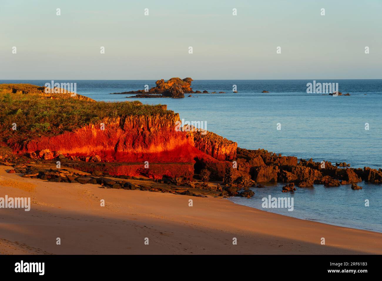 Rugged rocks around Mercedes Cove on Pender Bay at sunrise Stock Photo ...
