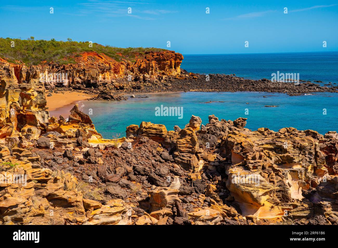 Rugged rocks around Mercedes Cove on Pender Bay at sunrise Stock Photo ...