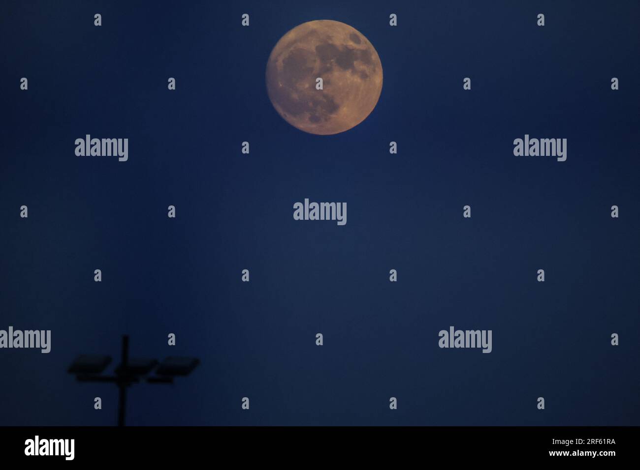 DALLAS, TX, USA. 31st July, 2023. A full moon is seen in contrast to an ...