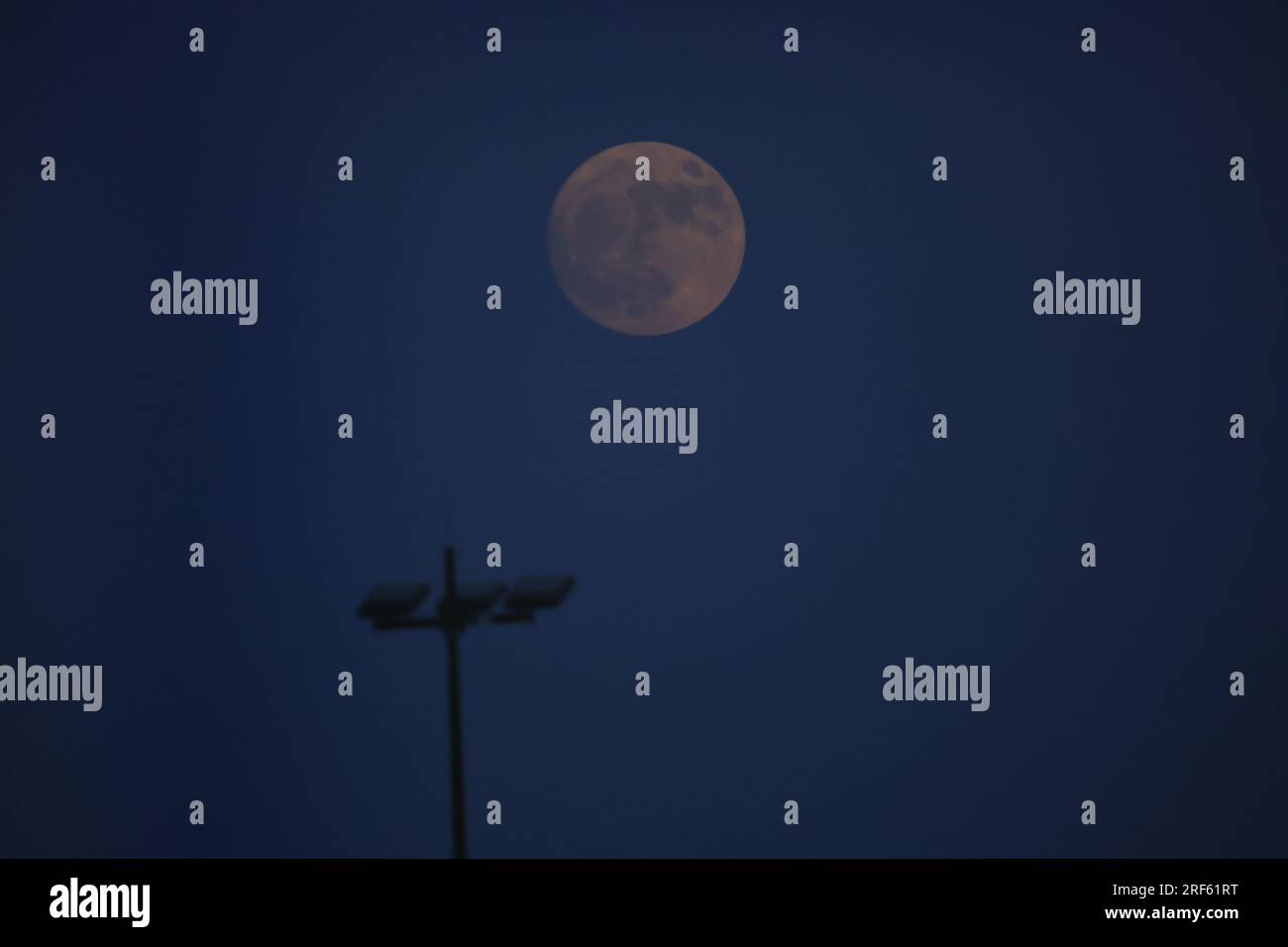 DALLAS, TX, USA. 31st July, 2023. A full moon is seen in contrast to an ...