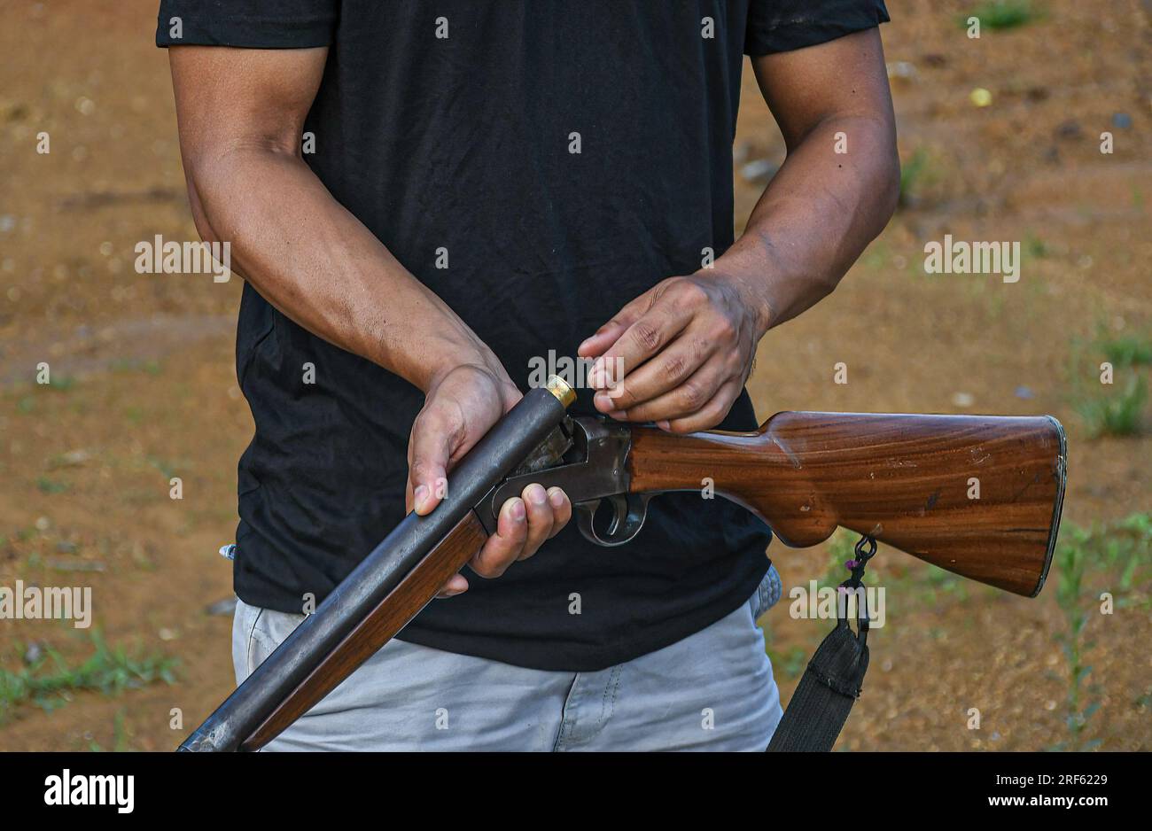 A youth loads a cartridge into a single-barreled rifle during a ...