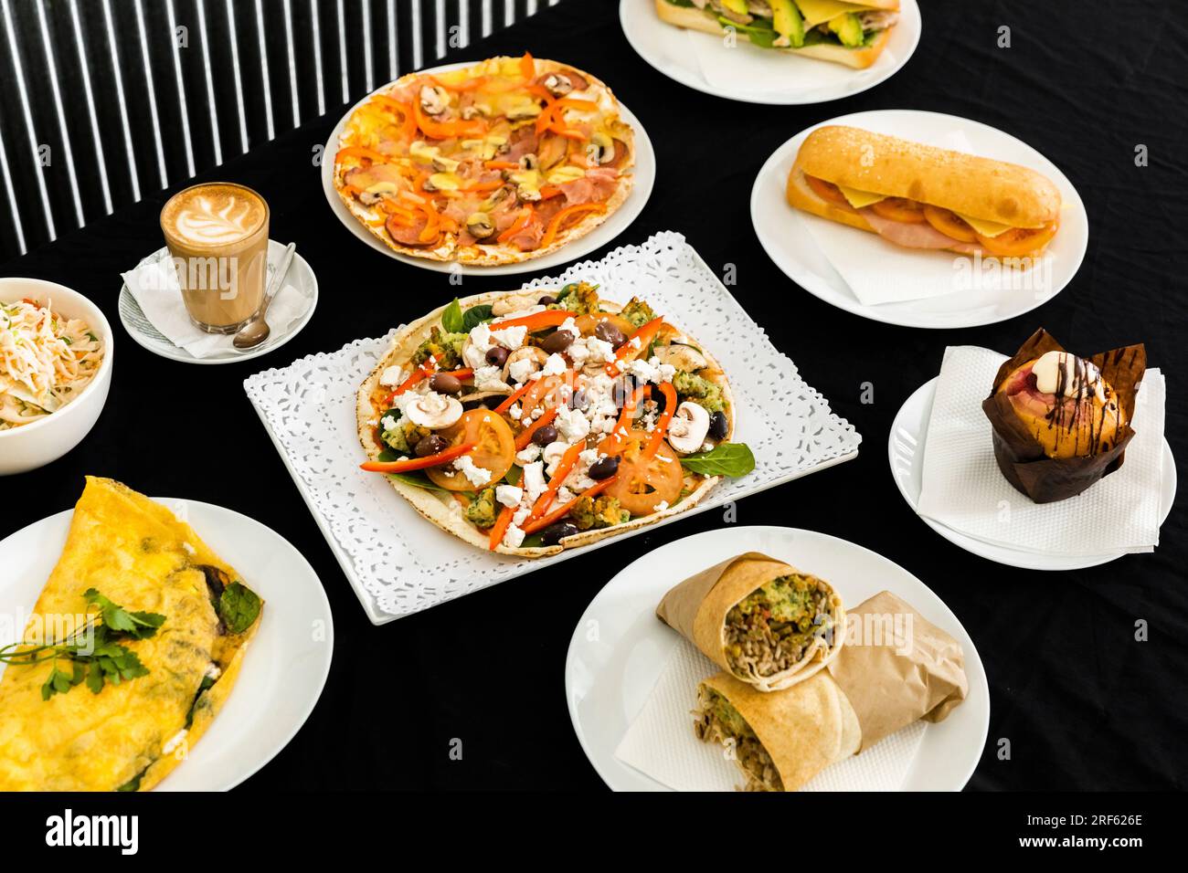 An array of delectable cafe menu items artfully arranged on a table ...