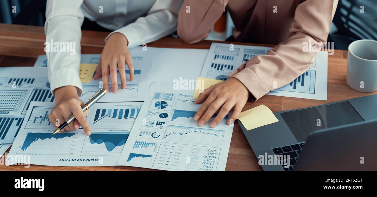 Closeup analyst team colleagues discuss financial data on digital ...