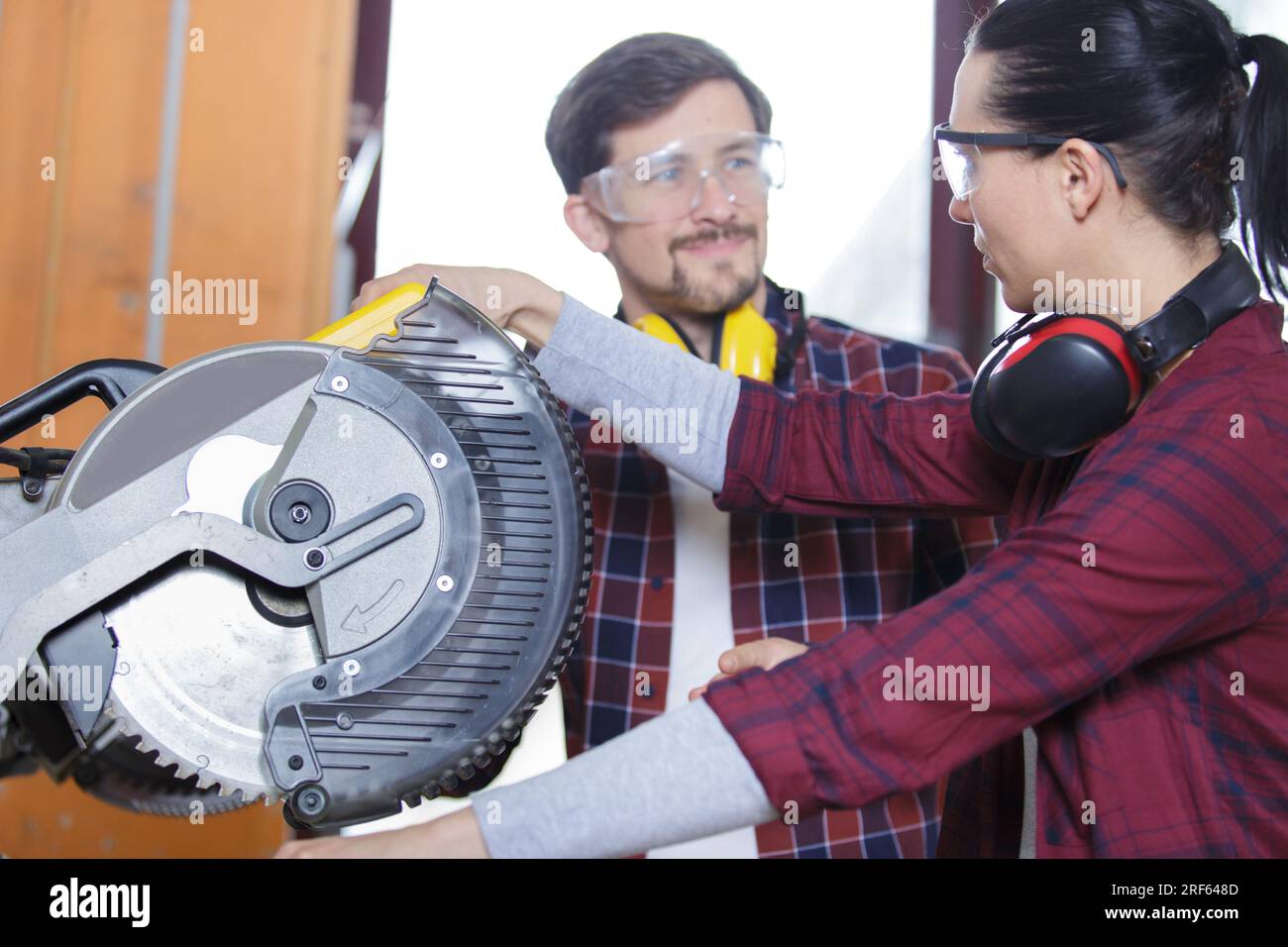 diligent friendly smiling male worker with female apprentice Stock ...