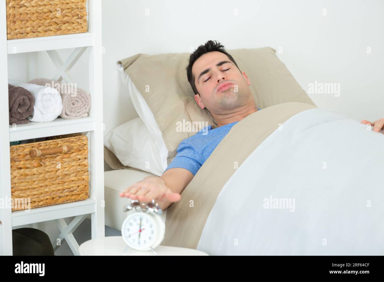 Man alarm clock switch off hi-res stock photography and images - Alamy