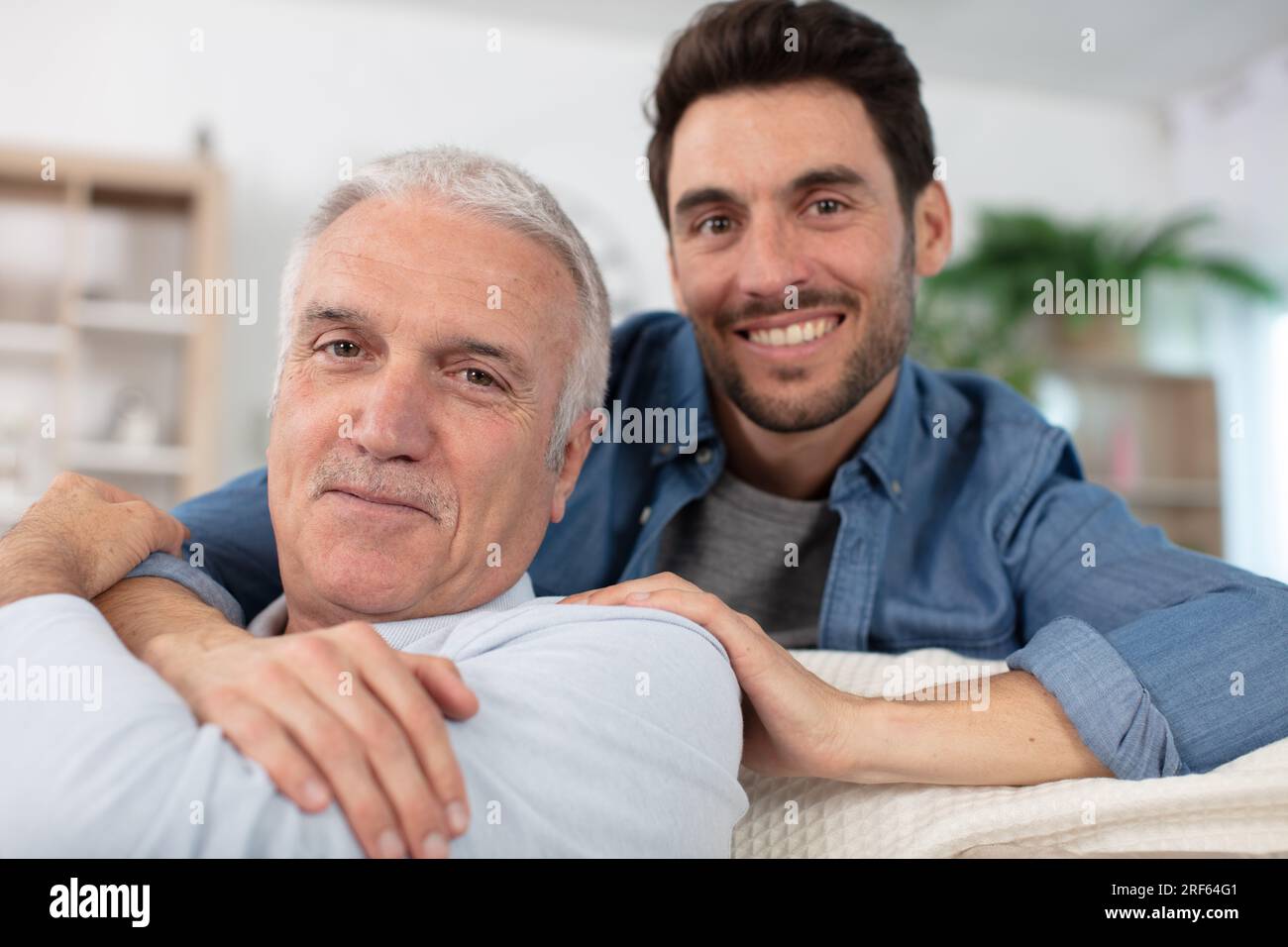 happy old senior dad embracing grown son Stock Photo - Alamy