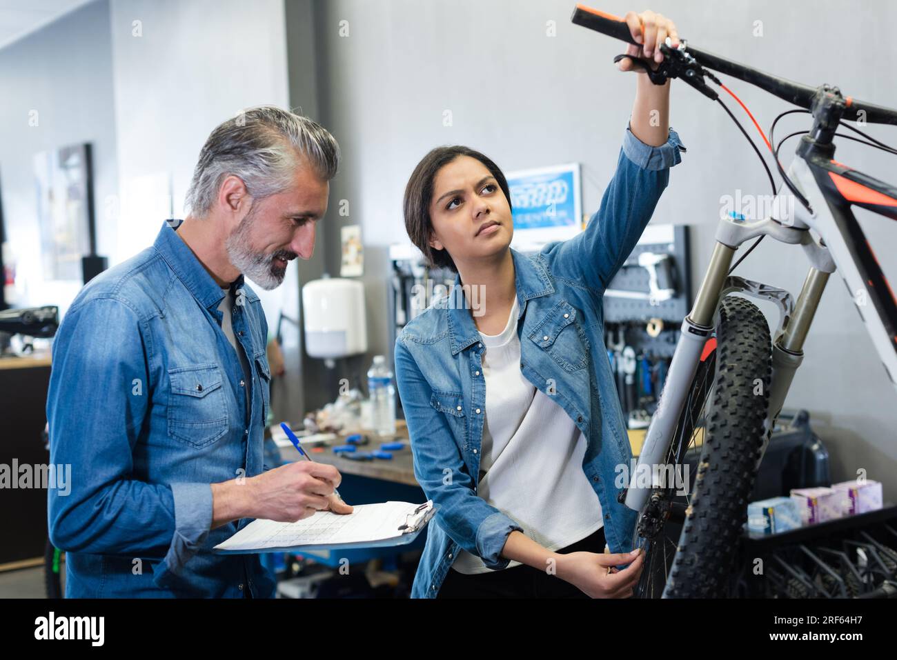 Bicycle repair workshop workers hi-res stock photography and images - Alamy