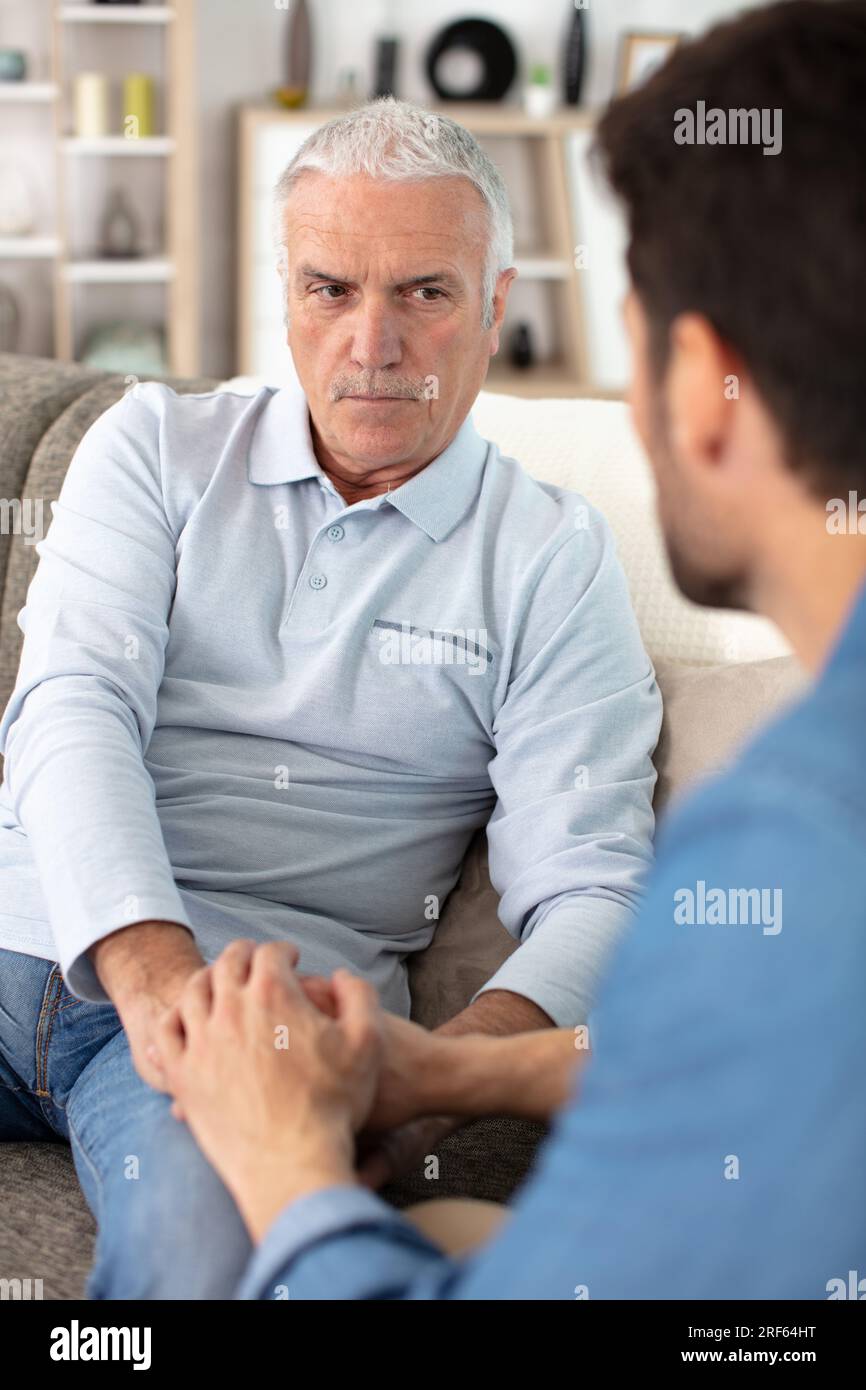 Father supporting sad son hi-res stock photography and images - Alamy