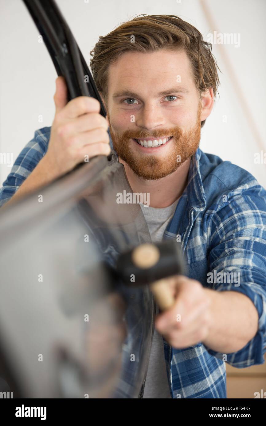 coachbuilder using a hammer to bend a car door Stock Photo - Alamy