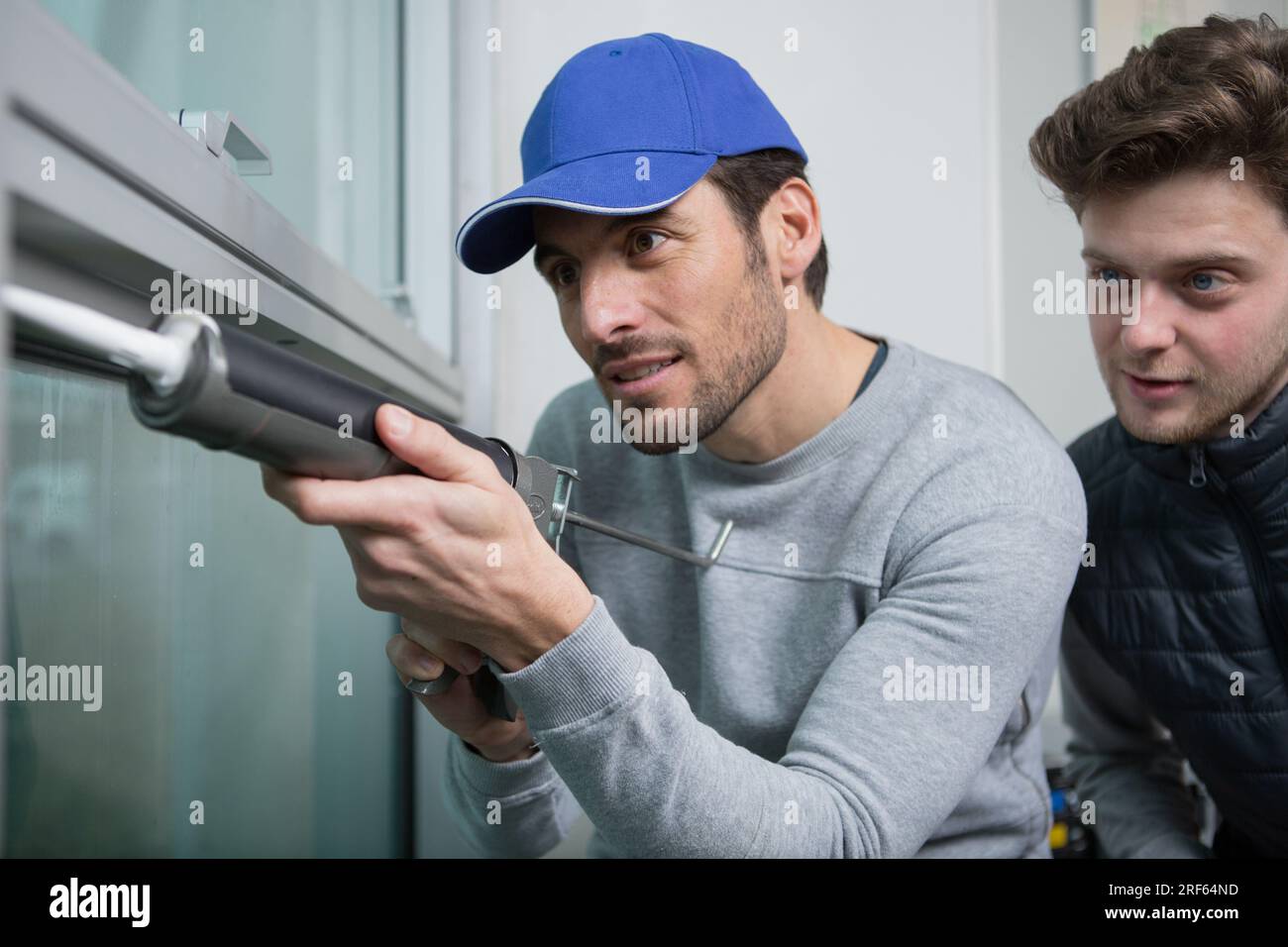 man using caulking gun Stock Photo - Alamy