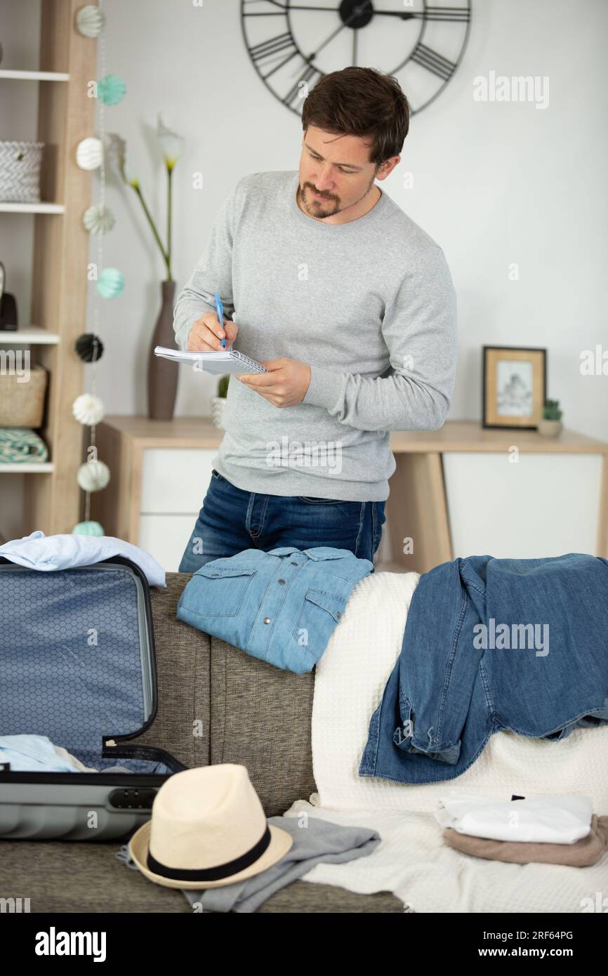 man packing the luggage for their journey trip Stock Photo - Alamy