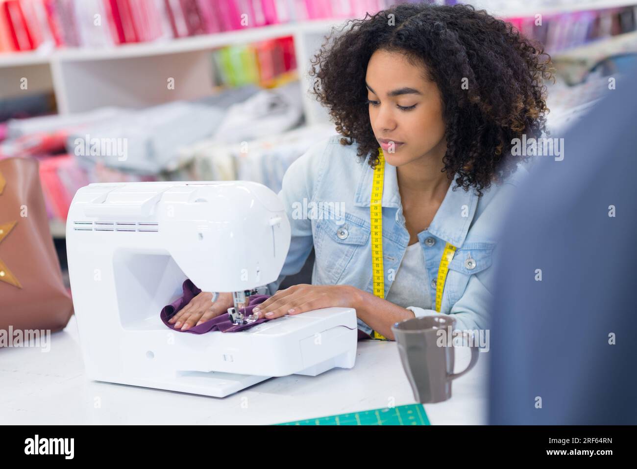 woman using sewing machine in dressmaking studio Stock Photo - Alamy