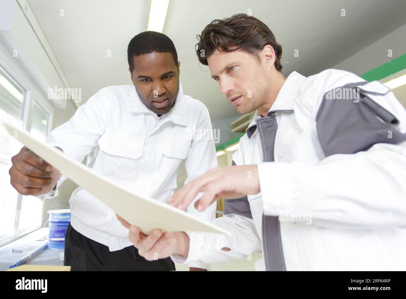 apprentice and painter at work Stock Photo - Alamy