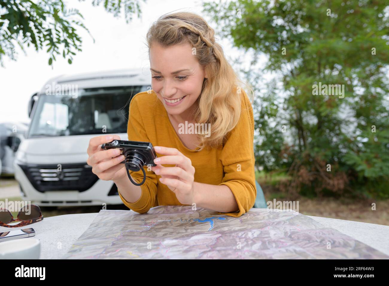 a lady taking pictures of a map Stock Photo - Alamy