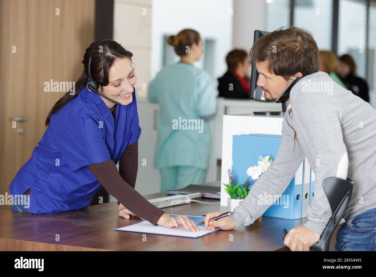 doctor helping patient with crutches Stock Photo - Alamy