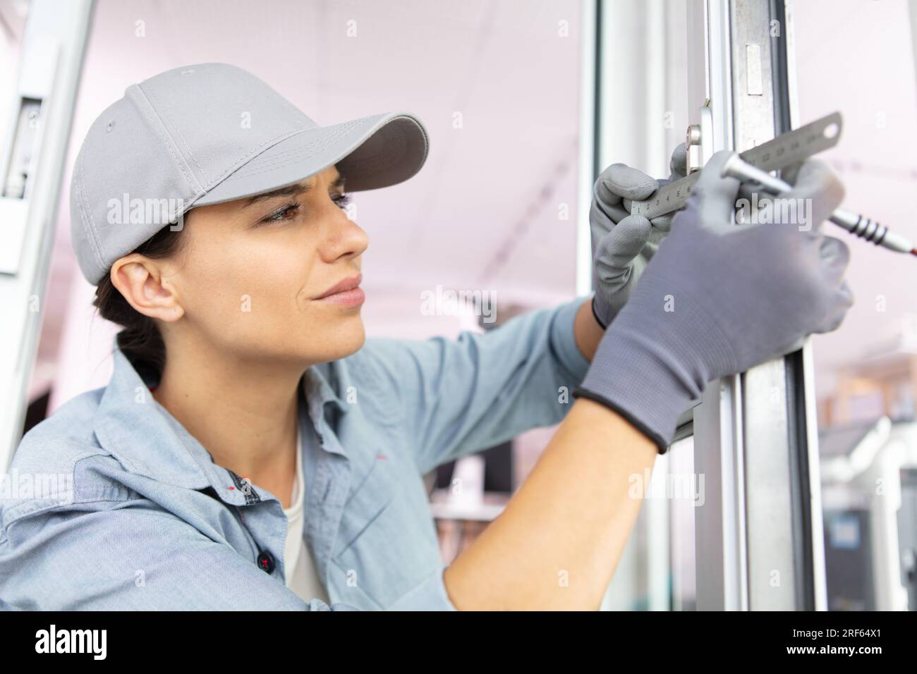 pretty young woman construction worker about to fix window Stock Photo ...