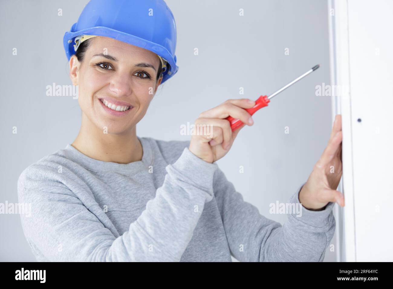 woman tightens the screw in the repair process Stock Photo - Alamy