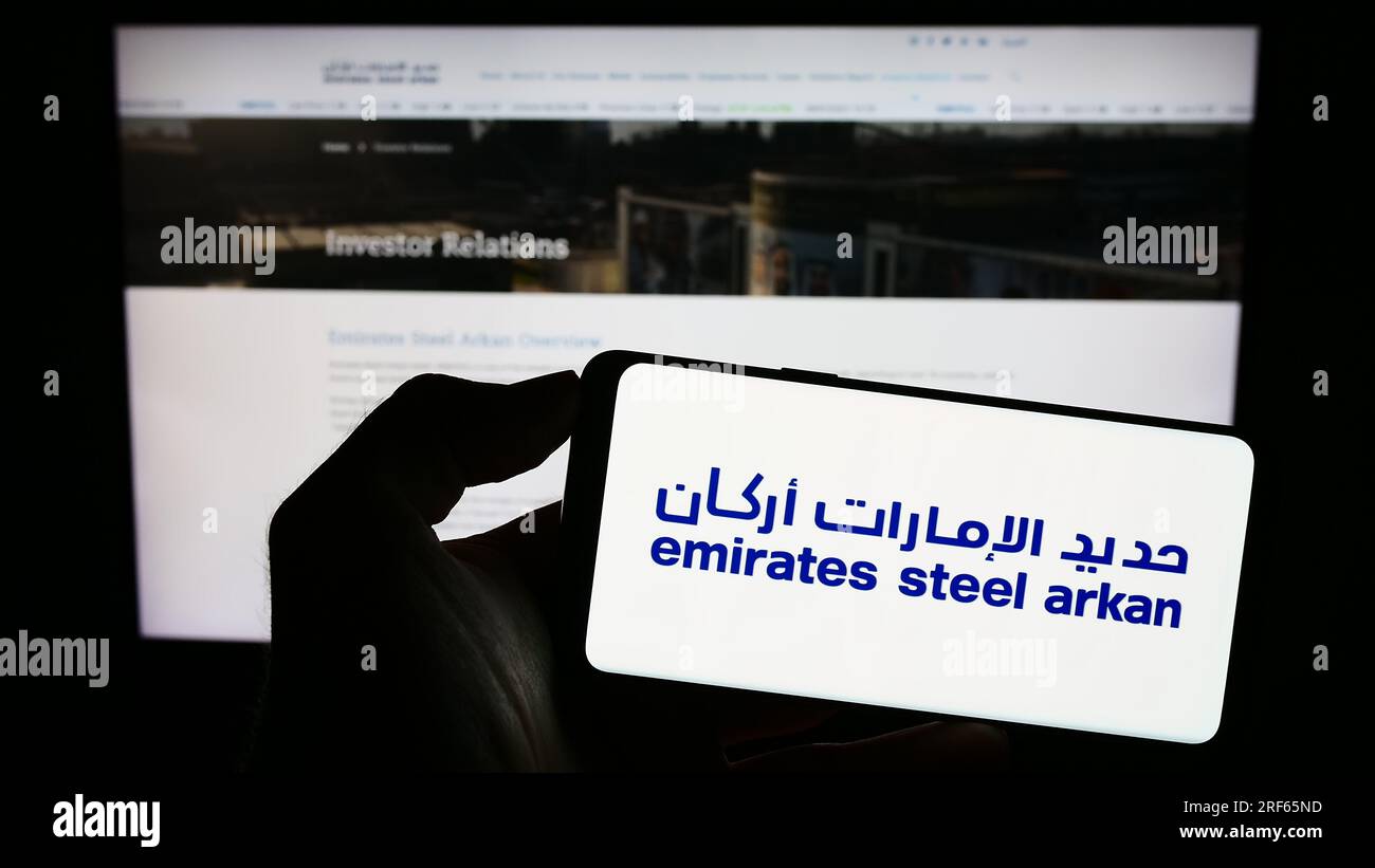 Person holding smartphone with logo of company Emirates Steel Arkan ...