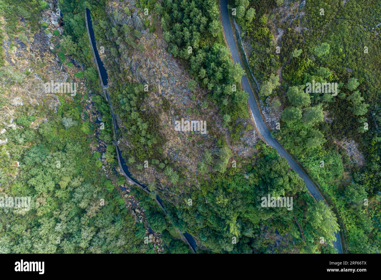 Aerial view of a water channel and a mountain road in a forest Stock ...