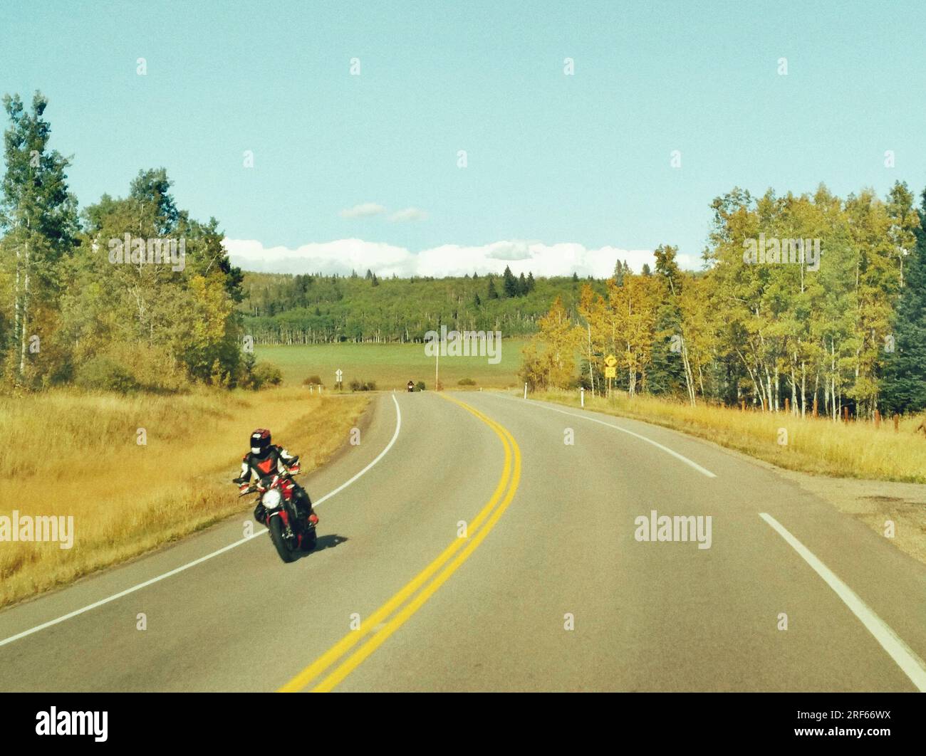 View from a moving car vehicle overlooking a motorcycle riding on ...