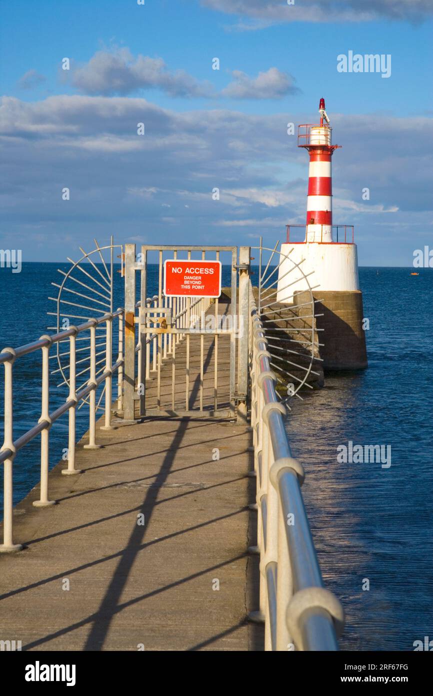 red and white lighthouse on Amble pier on the northumberland coast ...
